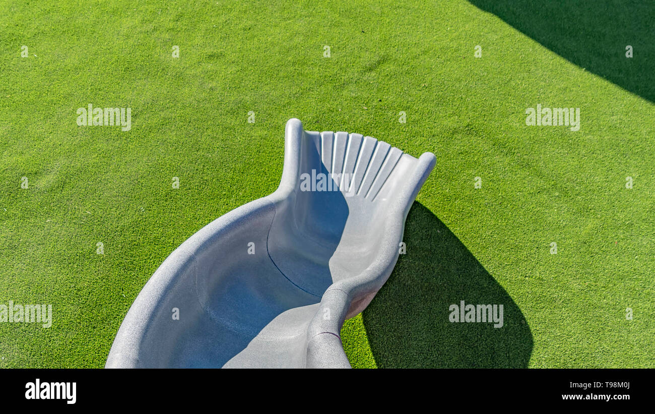 Panorama Playground with smooth and shiny gray slide against a vibrant ...