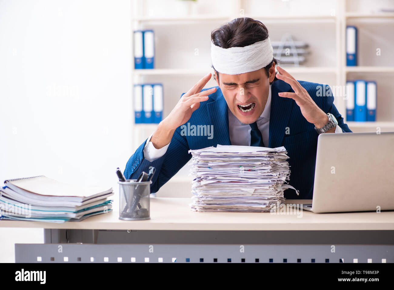 Head injured male employee working in the office Stock Photo - Alamy