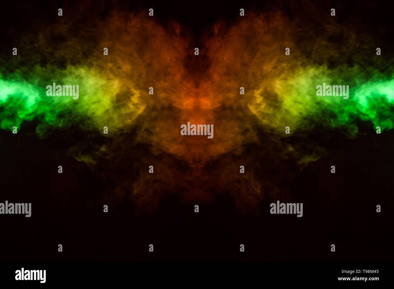 Smoke of different green, yellow, orange and red colors in the form of ...