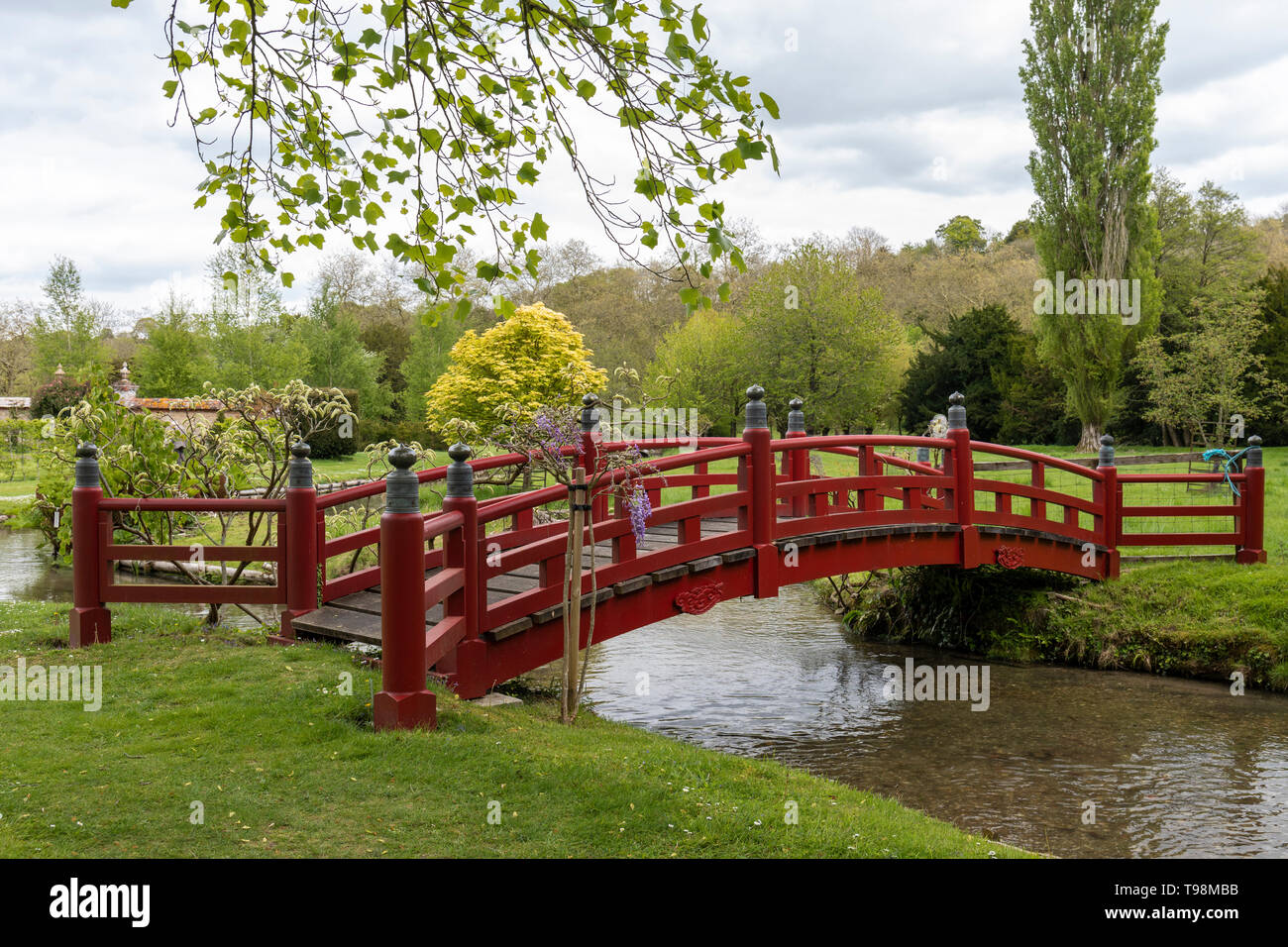 Red wooden pedestrian bridge in the gardens of Heale House, Woodford ...