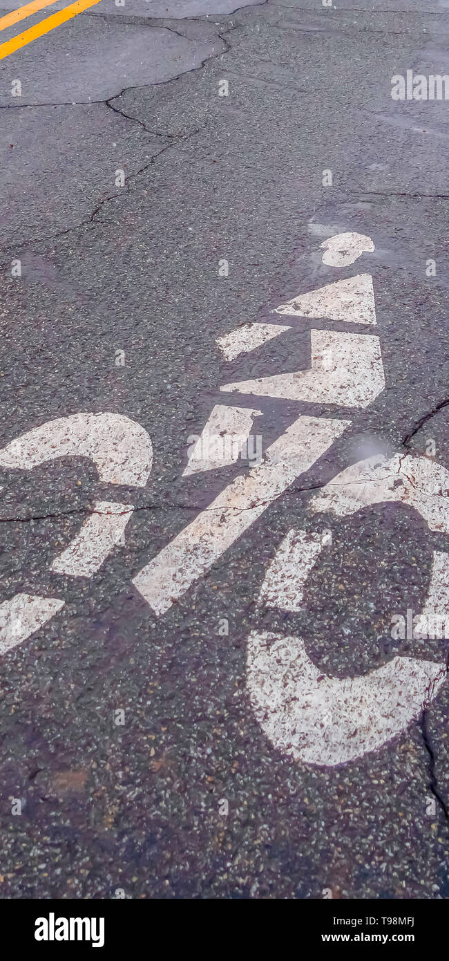 Clear Vertical Bicycle lane sign painted on a road with cracks Stock ...