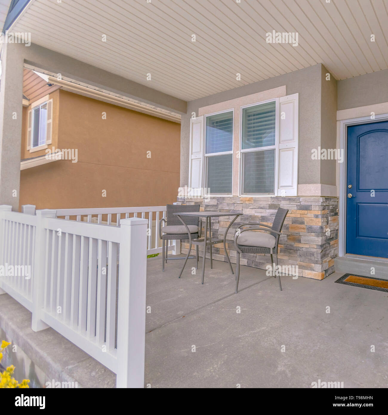 Clear Square Home exterior with a blue front door and reflective glass ...