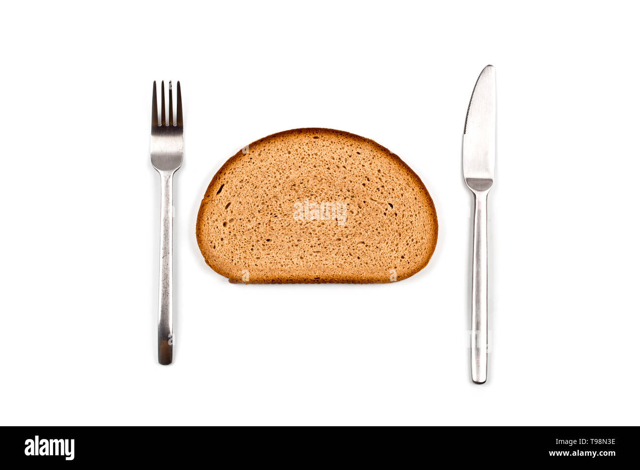 Fresh baked bread slice, fork and knife on white background. Top view ...