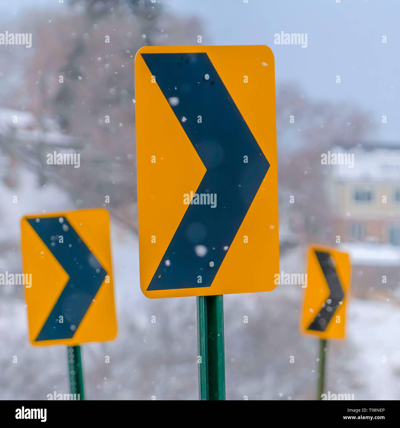Square Directional road signs against a snowy landscape Stock Photo - Alamy