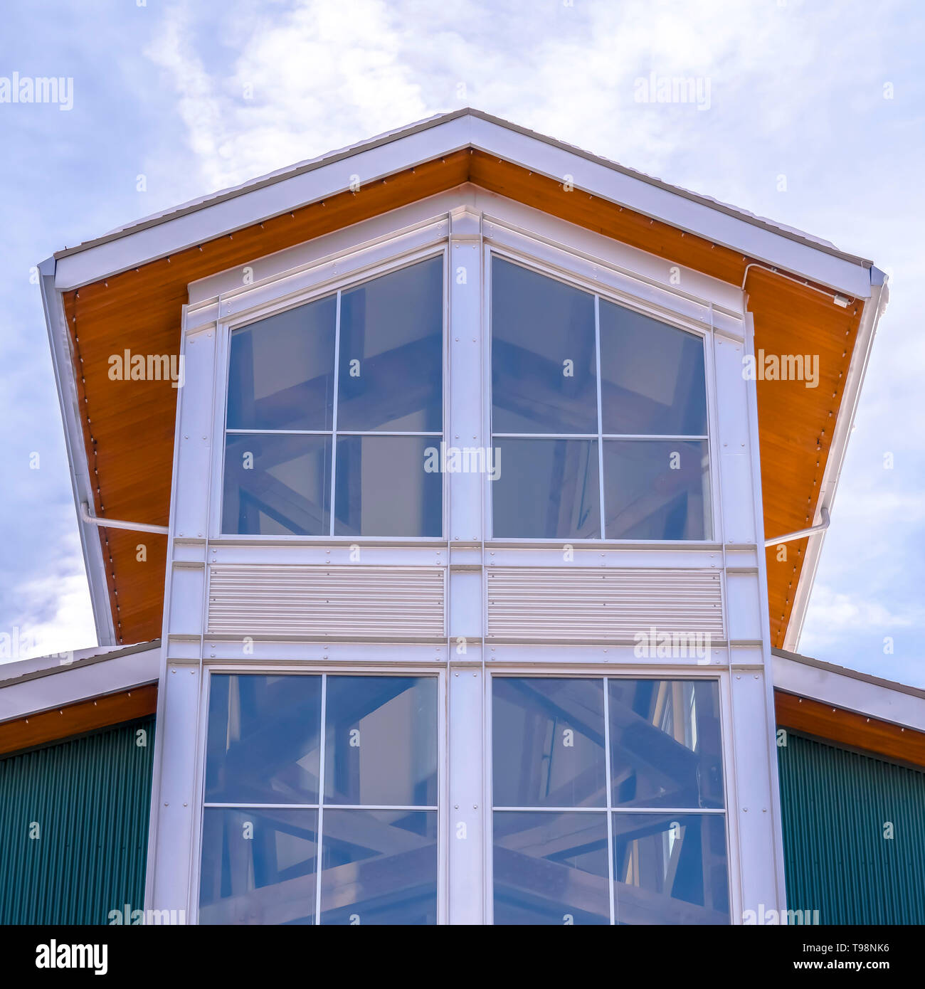 Square Large glass window of a building with a bright and cloudy blue ...