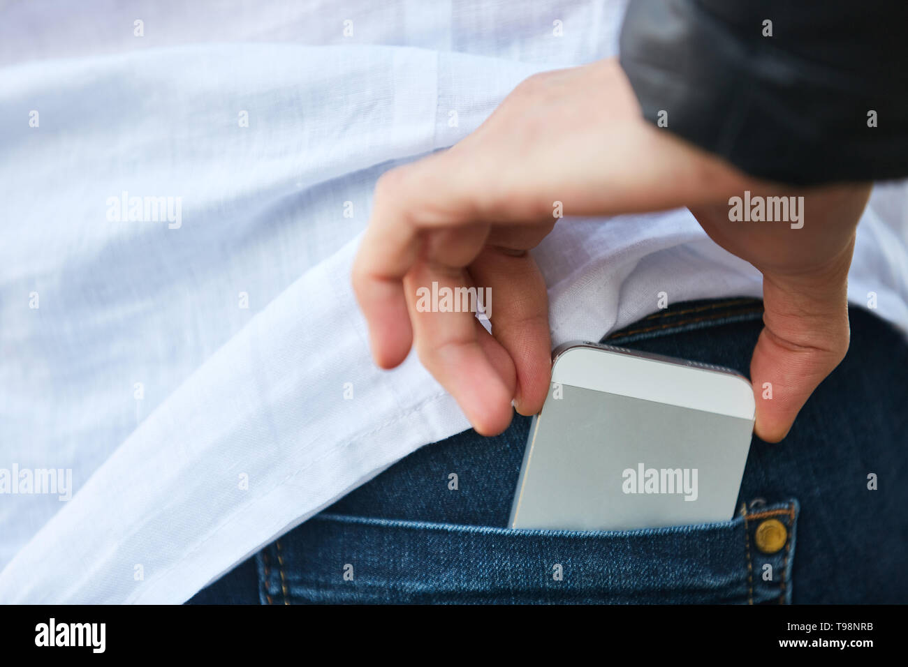 Thief stealing phone from bag hi-res stock photography and images - Alamy
