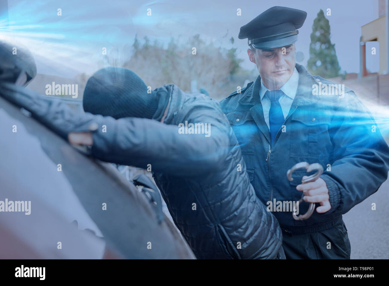 Policeman at burglar catching blue lights and handcuffs Stock Photo - Alamy