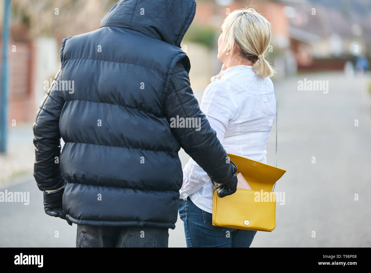 Pickpocket stealing wallet from the purse of a woman Stock Photo - Alamy