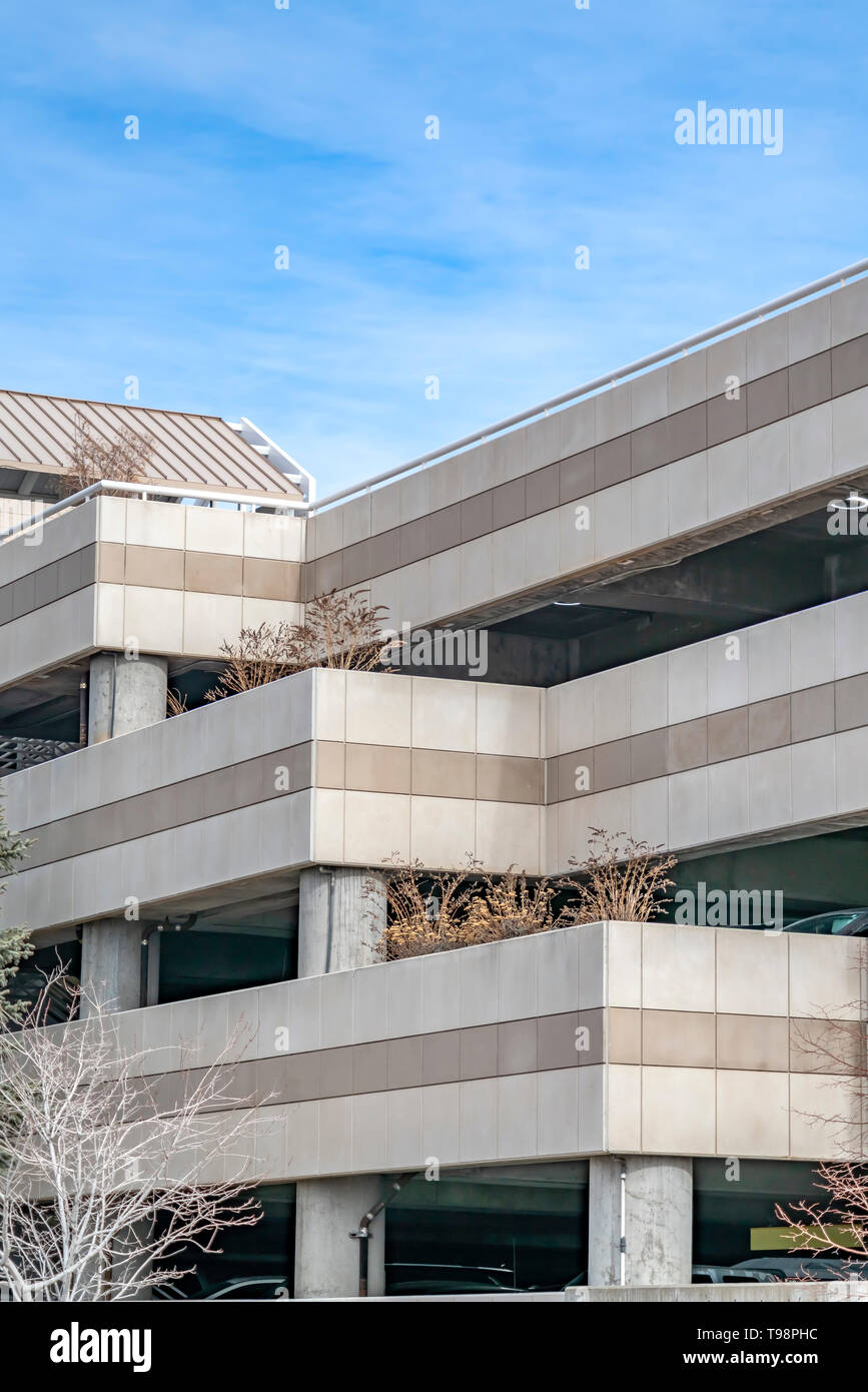 Exterior view of the covered parking lot of a building with vehicles ...
