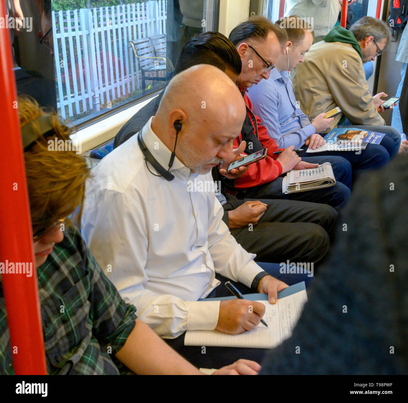 Commuters on a London Underground train Stock Photo - Alamy