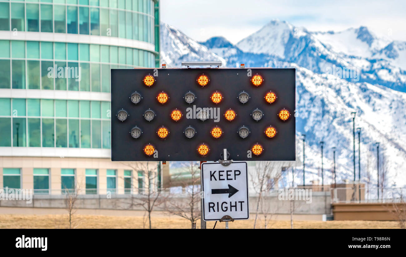 Clear Panorama Keep Right sign underneath an arrow board surrounded by ...