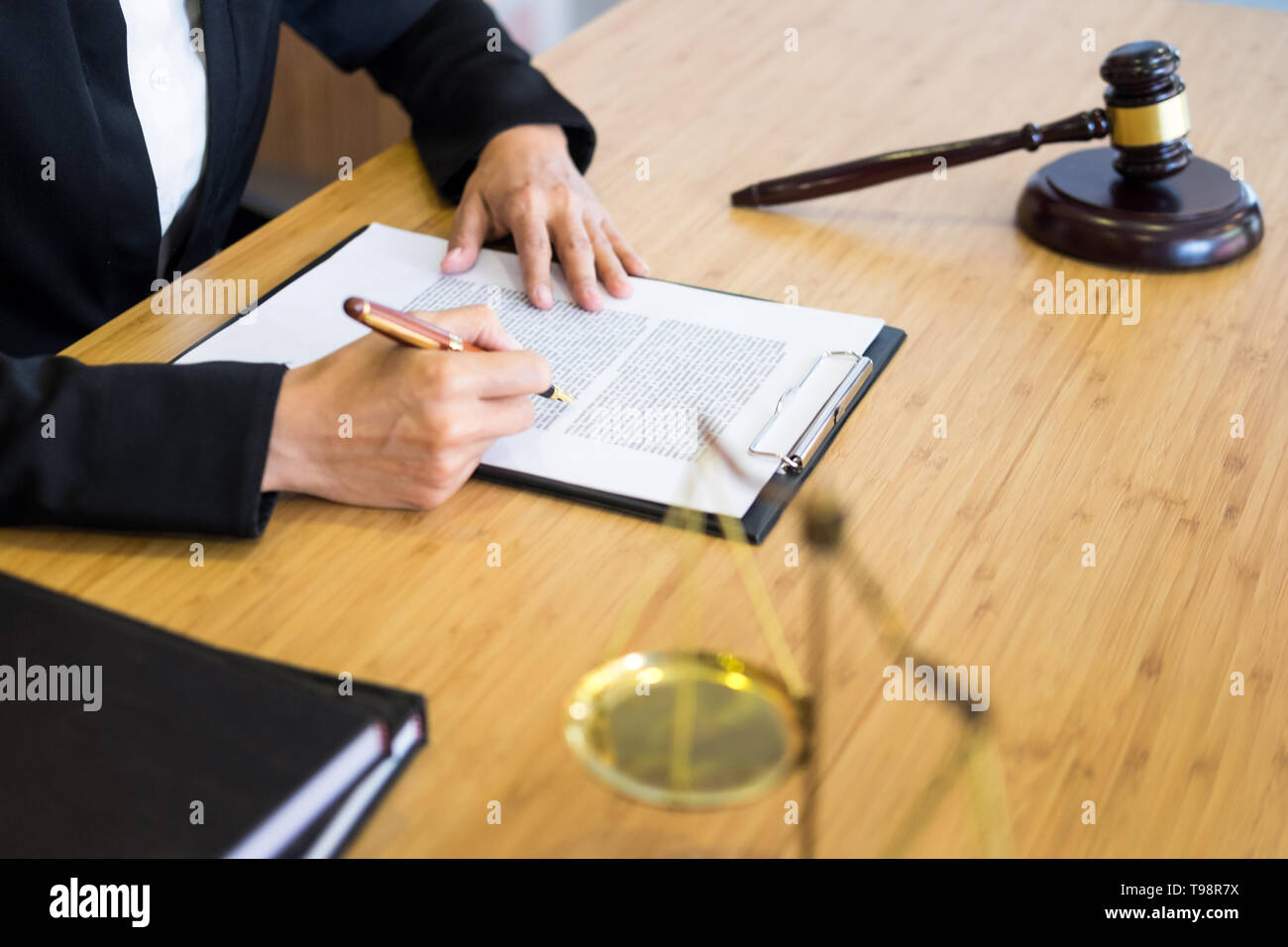 lawyer judge reading documents at desk in courtroom working on wooden ...