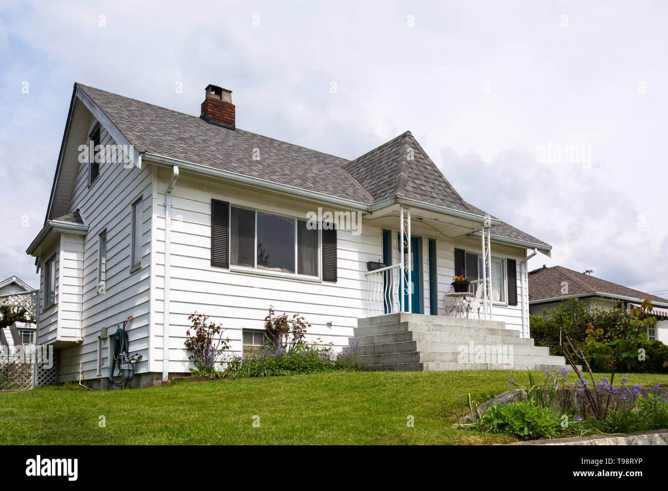 Modest family house on cloudy sky background Stock Photo - Alamy