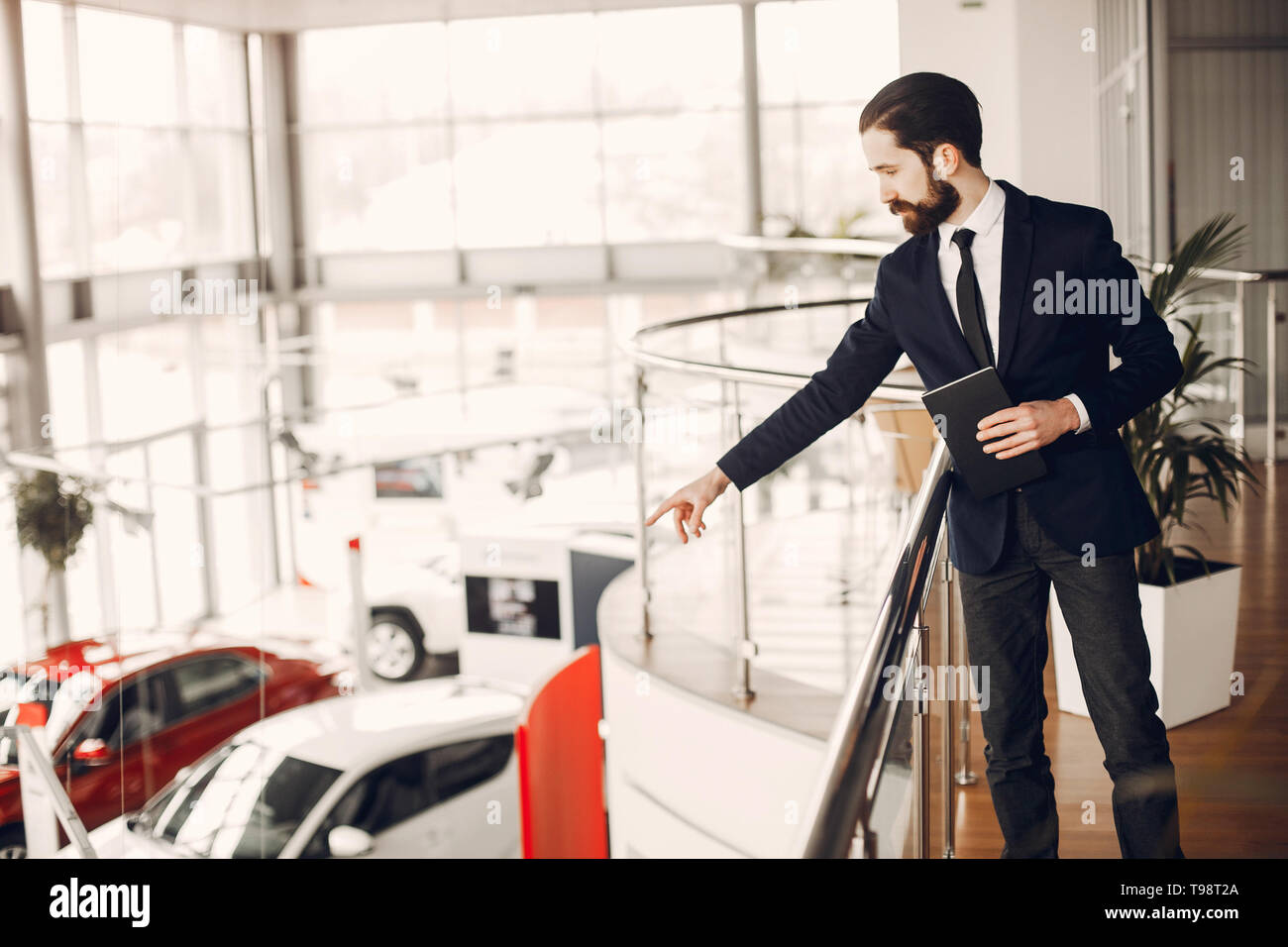 Handsome and elegant man in a car salon Stock Photo - Alamy