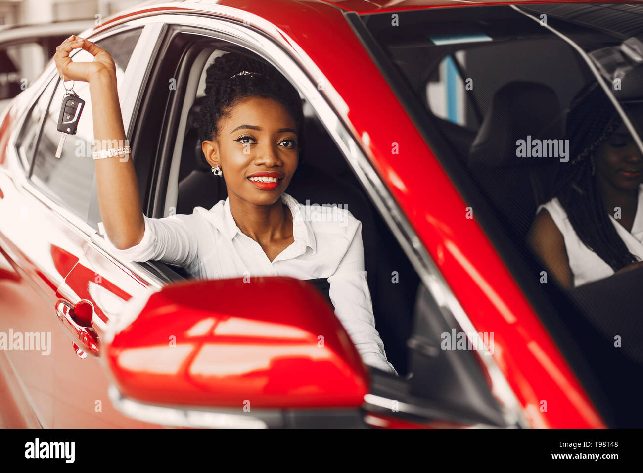 Two stylish black women in a car salon Stock Photo - Alamy