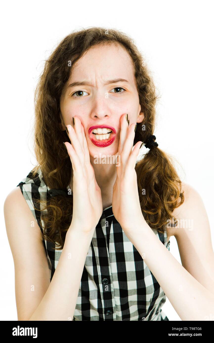 Teen girl in black checkered dress and dark make up makes shouting ...