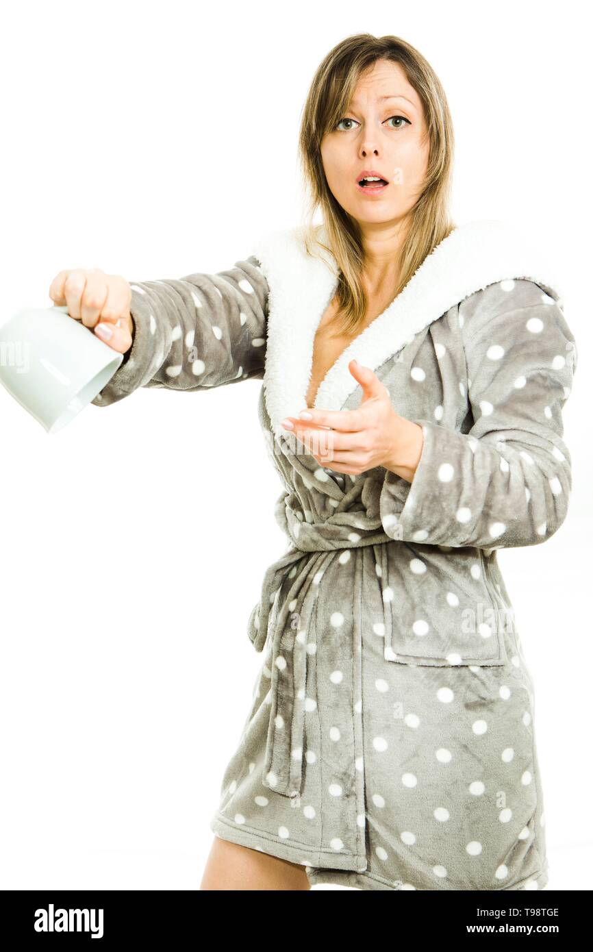 Blonde woman in gray dressing gown with dots show empty mug - no coffee ...