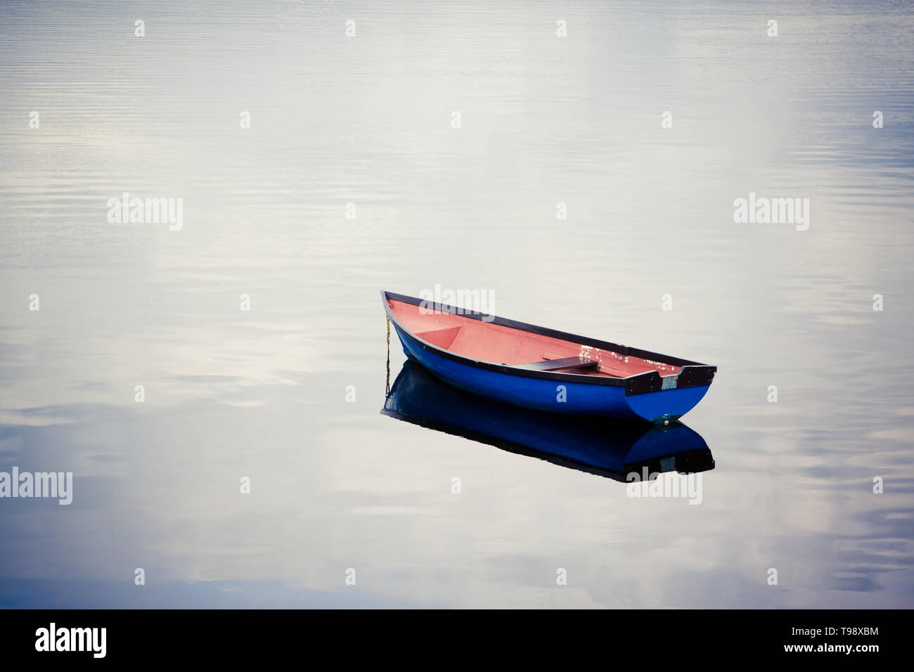 A small wooden boat in the sea Stock Photo - Alamy