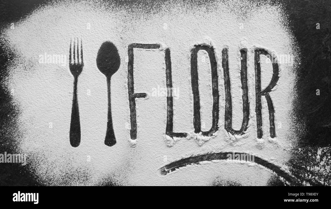Flour word write on flour with spoon and fork silhouette made with ...