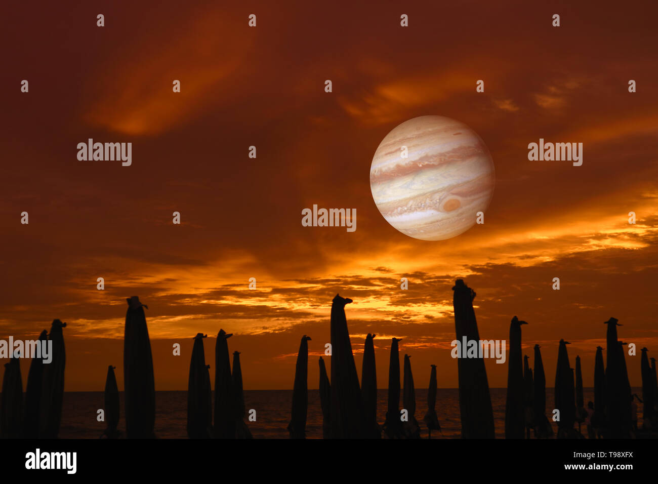 Jupiter on sky and sunset and the shadow of the beach umbrella. Folded ...