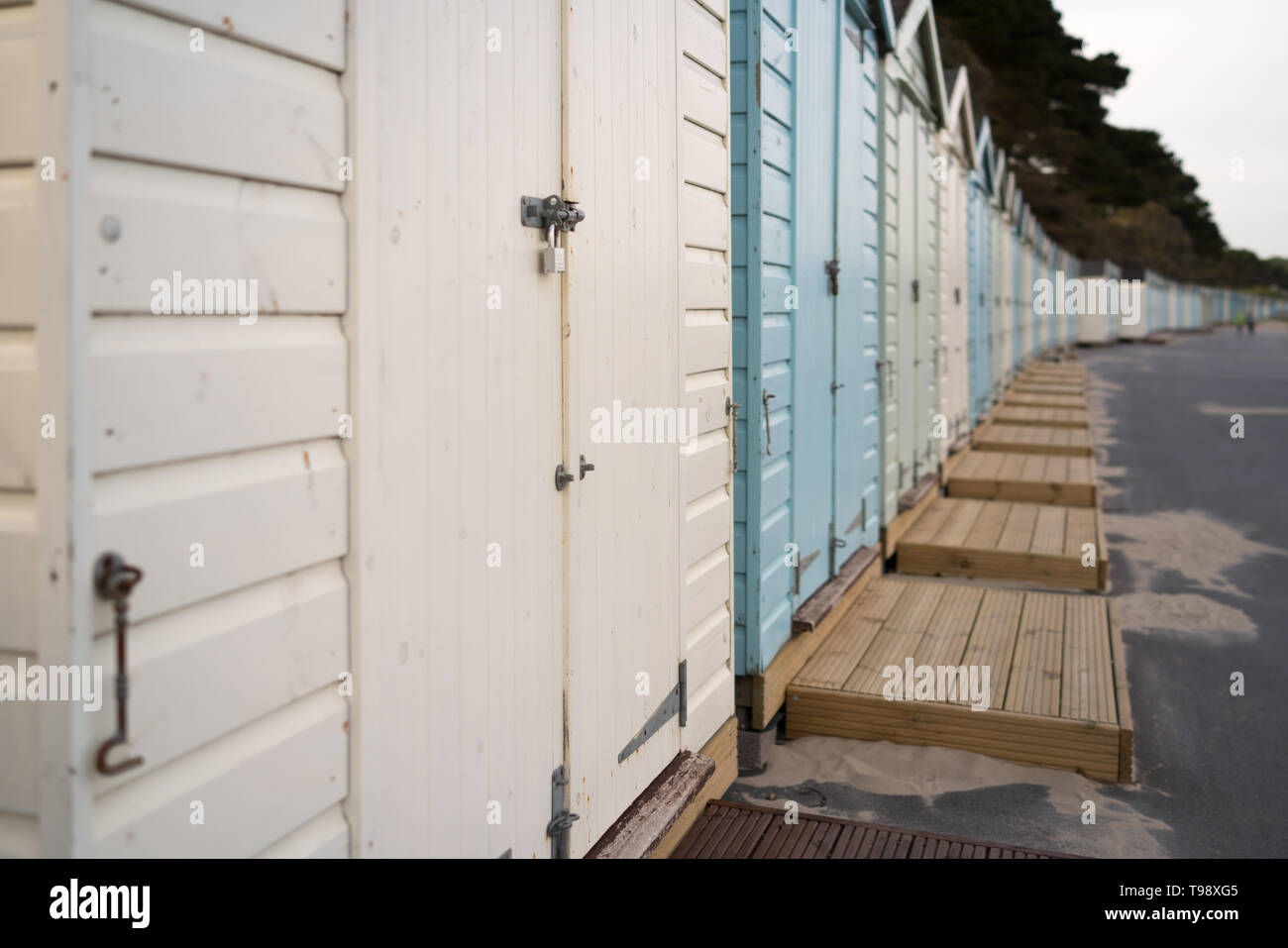 Beach huts at Avon Beach Mudeford stretching into distance Stock Photo ...