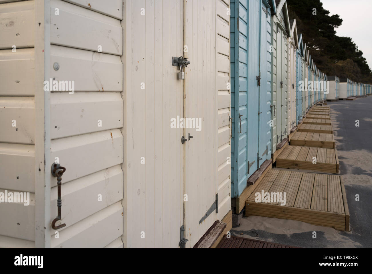 Beach huts at Avon Beach Mudeford stretching into distance Stock Photo ...