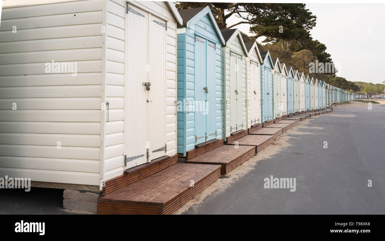 Beach huts at Avon Beach Mudeford stretching into distance Stock Photo ...