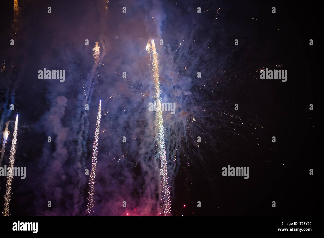 Explosive and colorful holiday fireworks at night sky. Celebration City ...