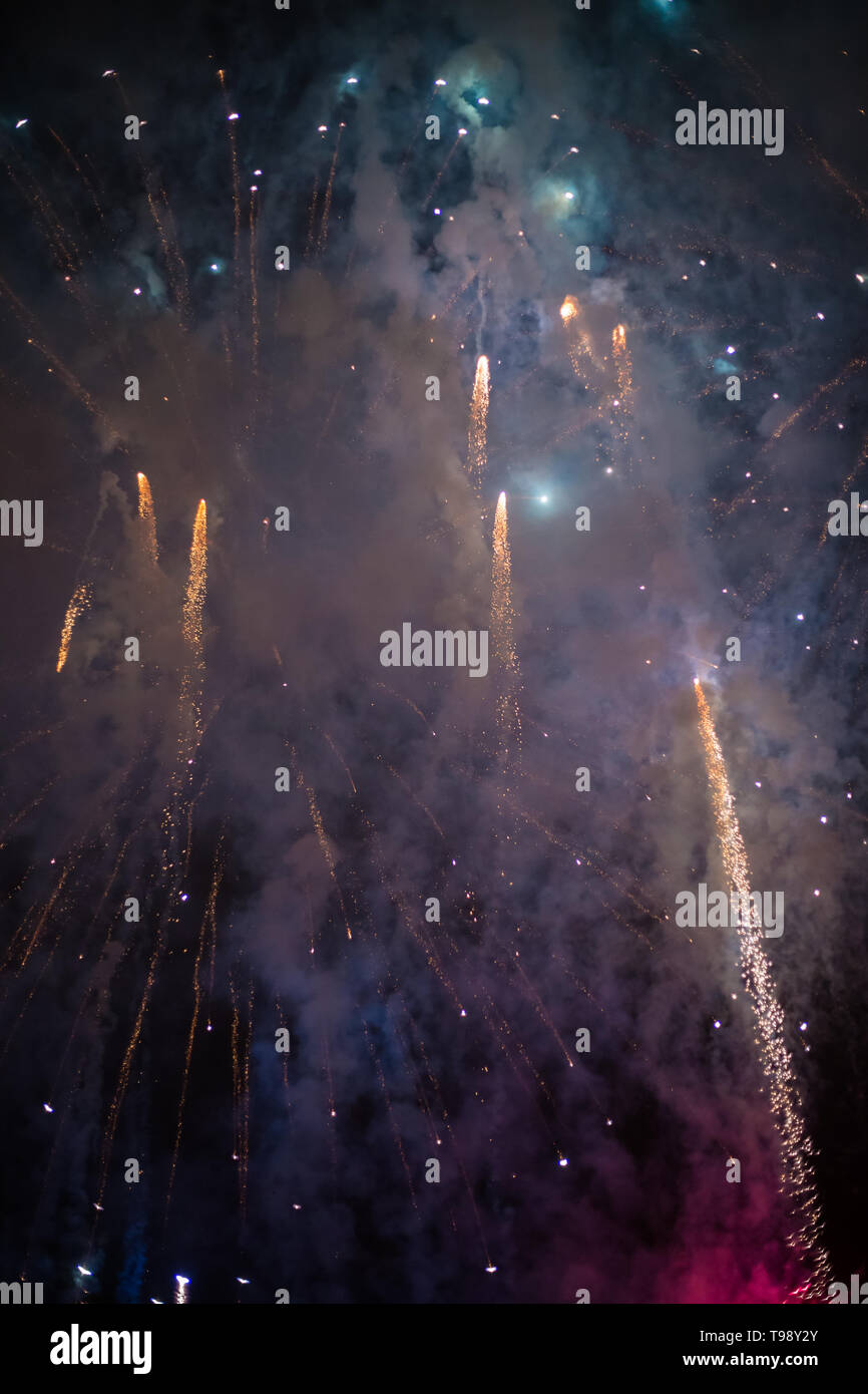 Explosive and colorful holiday fireworks at night sky. Celebration City ...