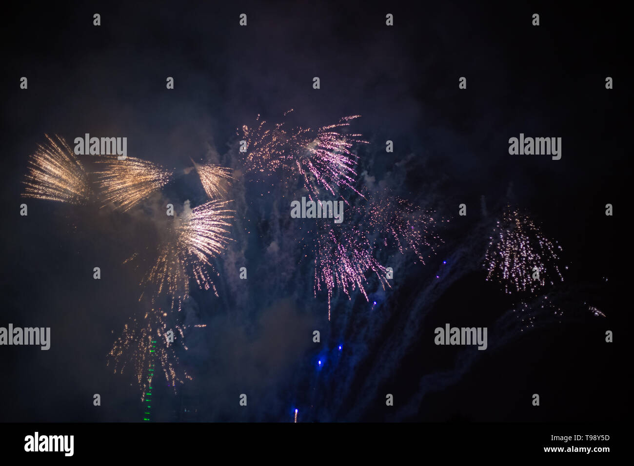Explosive and colorful holiday fireworks at night sky. Celebration City ...