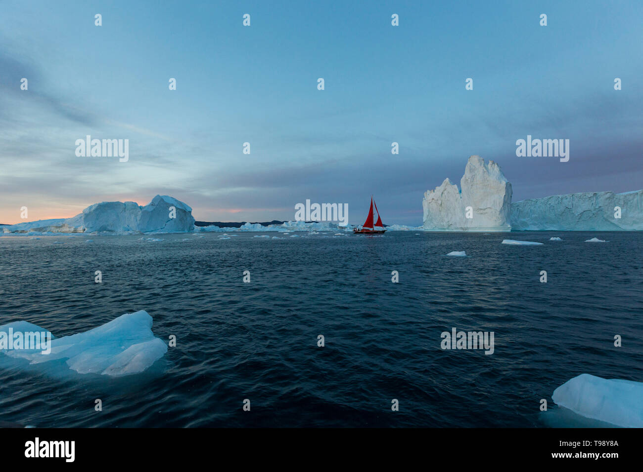 Icebergs and sailboat in Disko Bay on Midsummer, Greenland Stock Photo ...