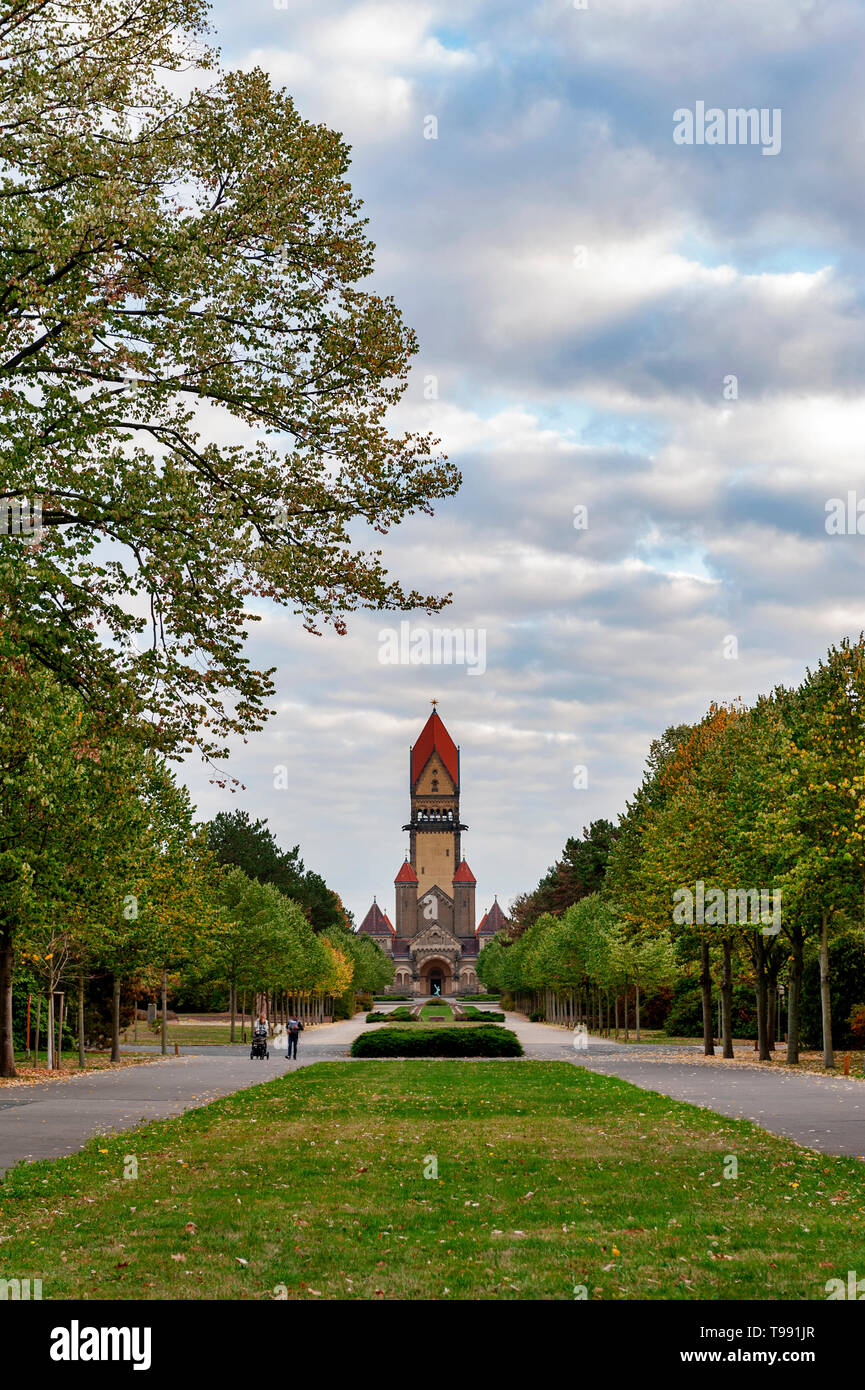 Walkway in beautiful park toward chapel complex, bell tower, funeral ...