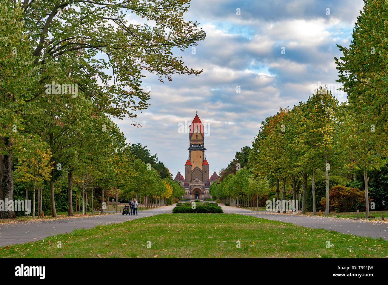 Walkway in beautiful park toward chapel complex, bell tower, funeral ...