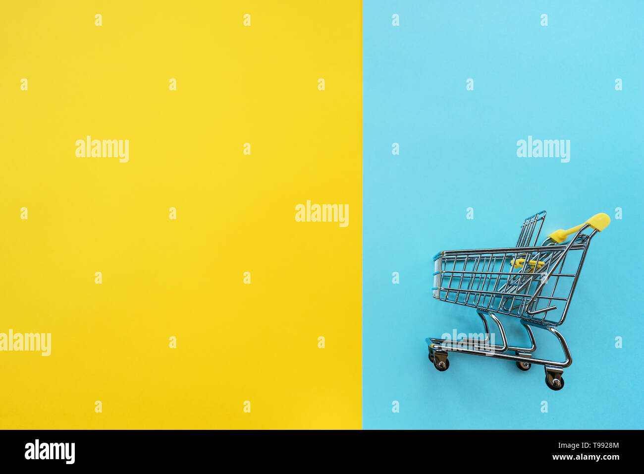 Toy cart for products on a two-color yellow-blue background Stock Photo ...