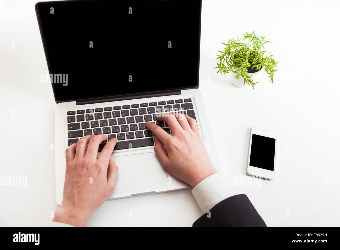 Man hand on laptop keyboard with blank screen monitor Stock Photo - Alamy