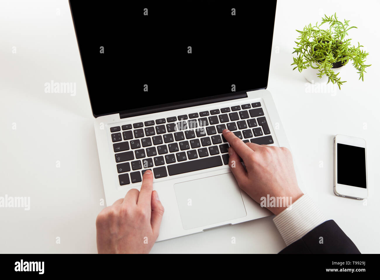 Man hand on laptop keyboard with blank screen monitor Stock Photo - Alamy