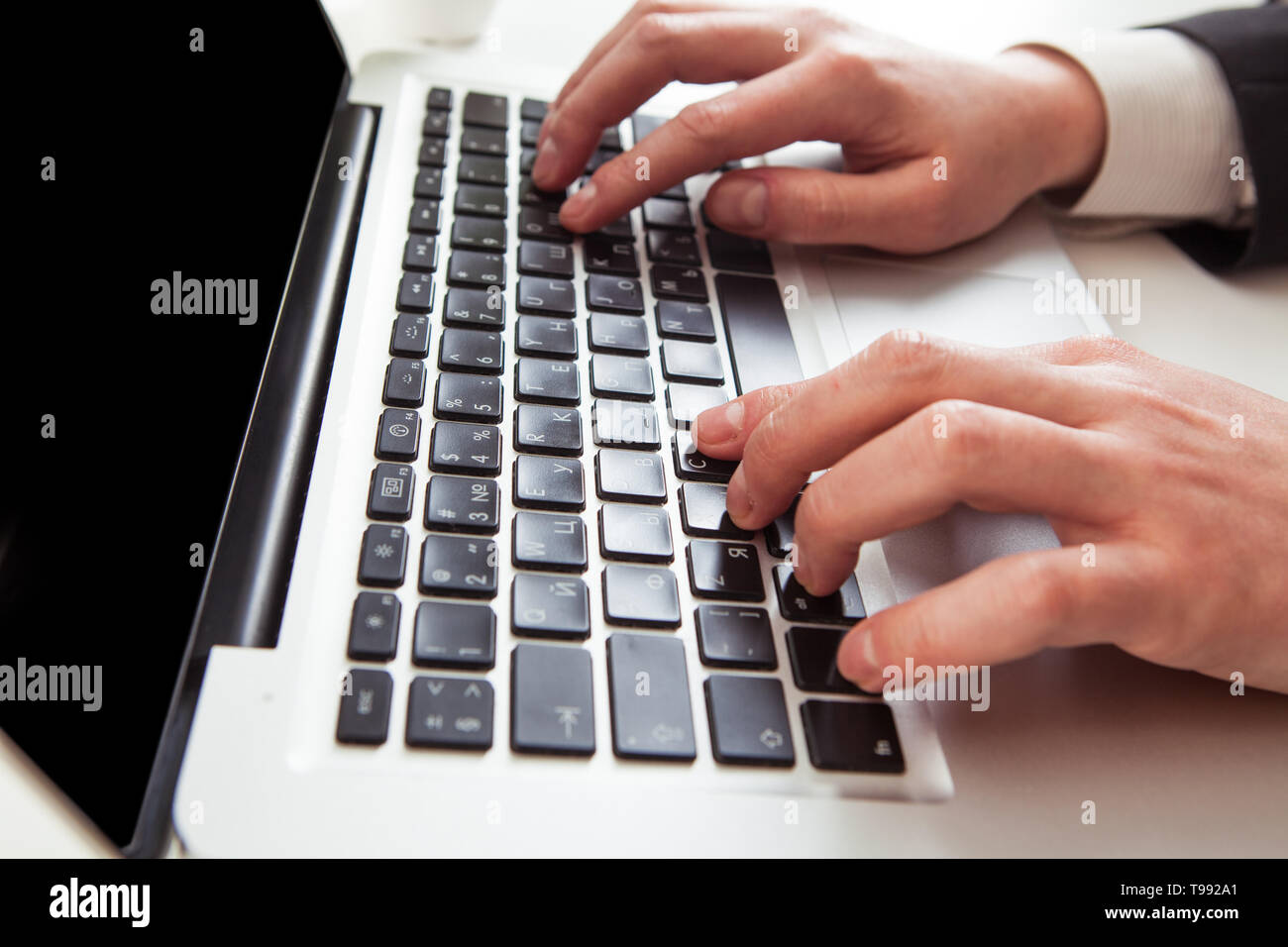 Man hand on laptop keyboard with blank screen monitor Stock Photo - Alamy