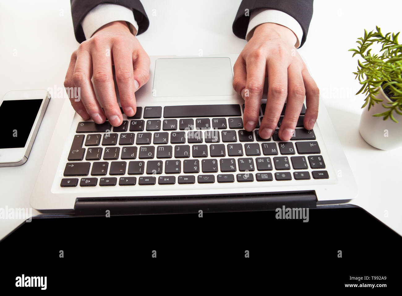 Man hand on laptop keyboard with blank screen monitor Stock Photo - Alamy