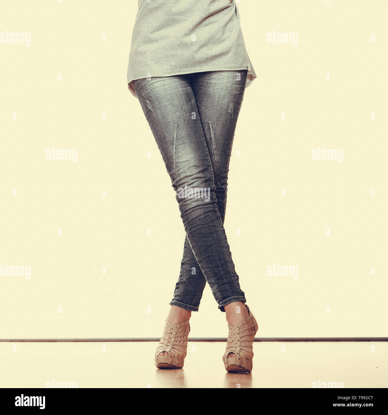 Fashion. Woman legs in denim trousers platform high heels shoes casual ...