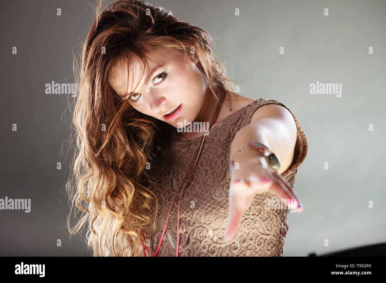 Portrait of mysterious enigmatic woman. Young intriguing attractive ...