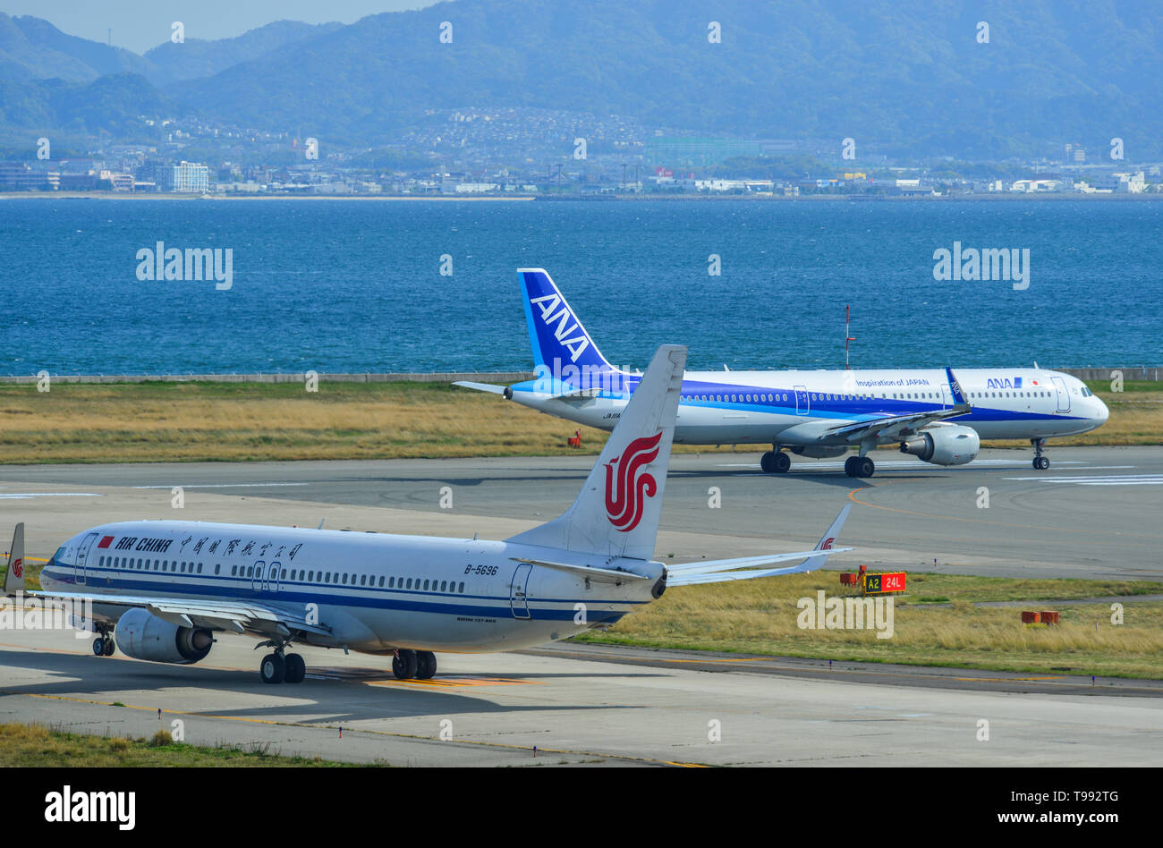 Osaka, Japan - Apr 19, 2019. Passenger airplanes taxiing on runway of ...
