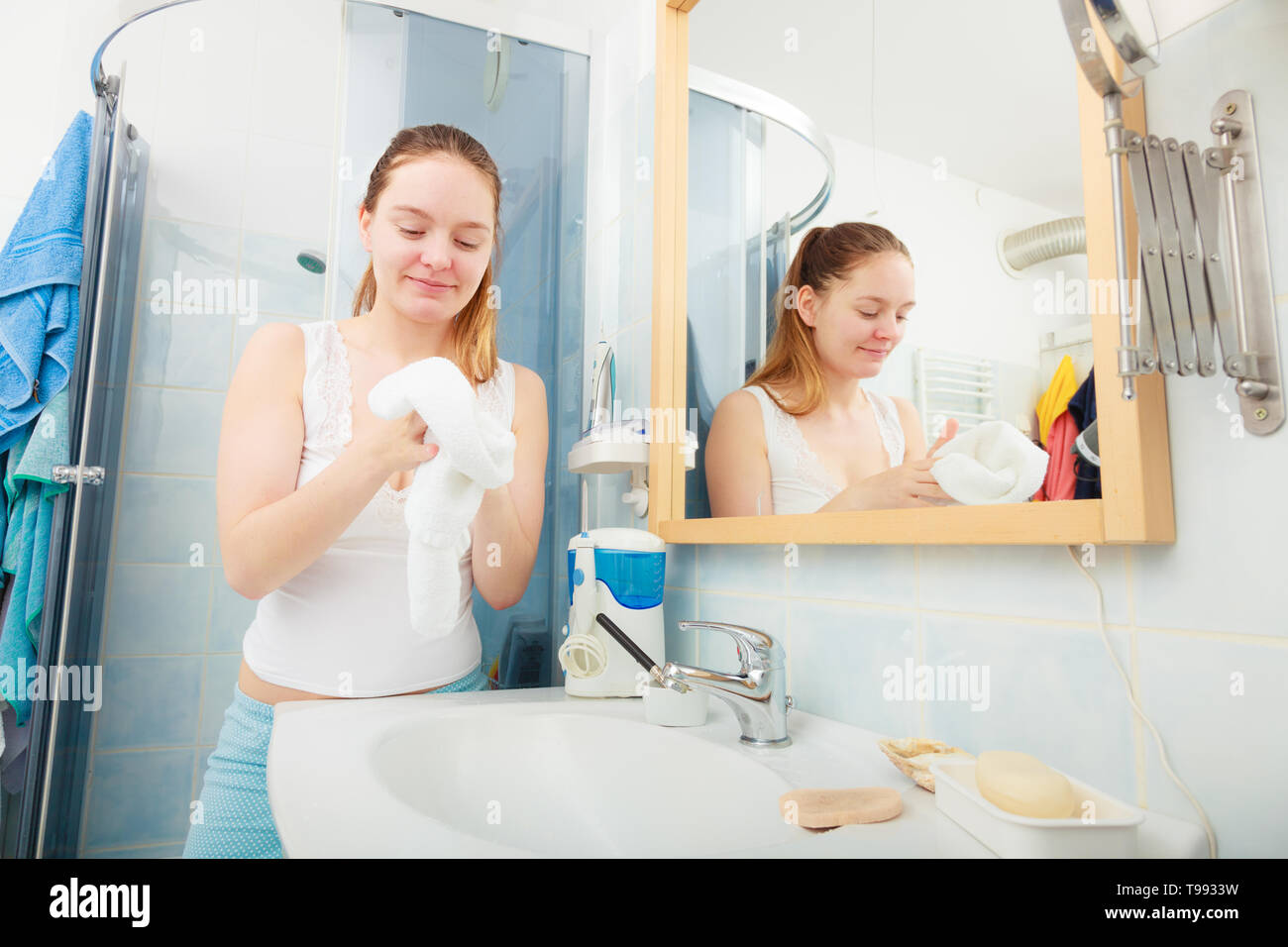 Morning hygiene. Woman cleaning washing her face with clean water in ...
