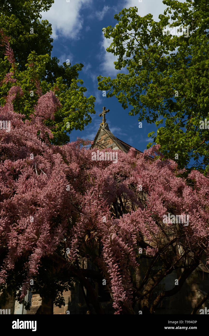 Close-up of cross on church in village of Alcester in the spring ...