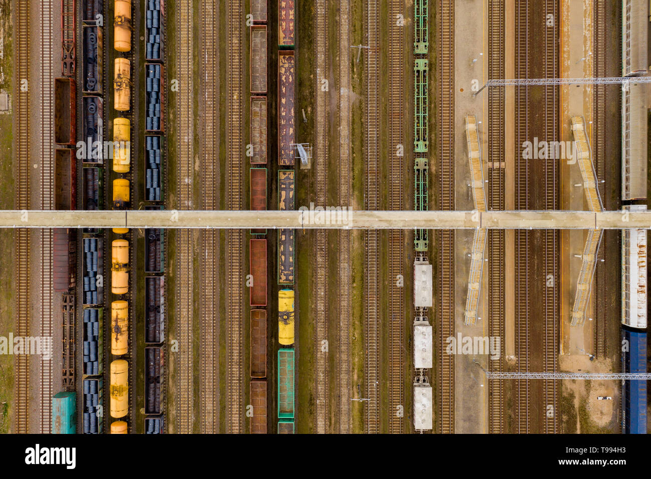 Aerial view of colorful freight trains with goods and bridge on the ...