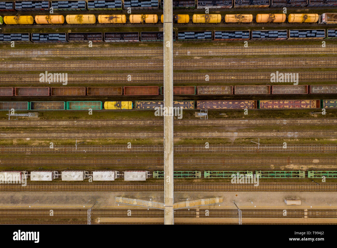 Aerial view of colorful freight trains with goods and bridge on the ...