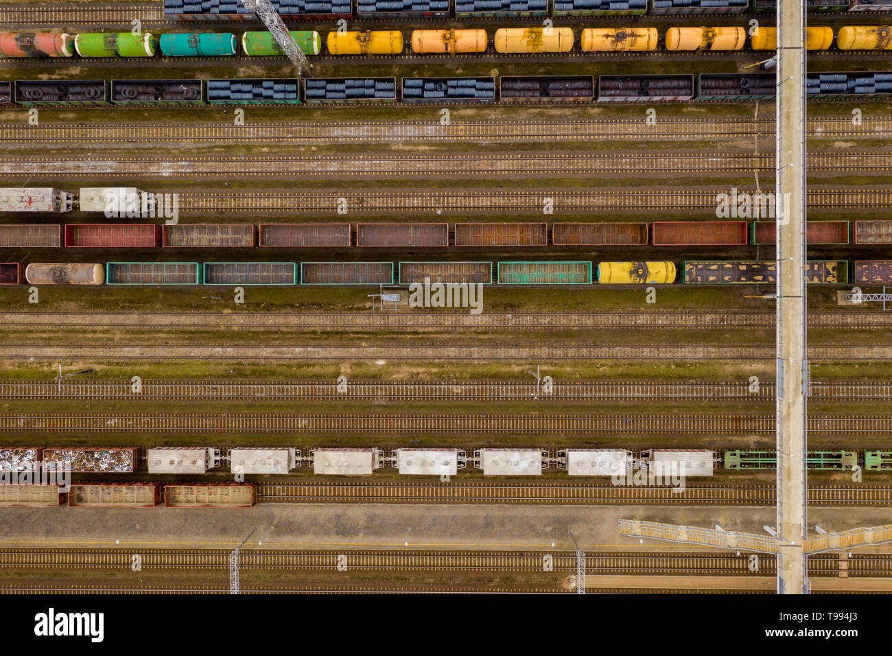 Aerial view of colorful freight trains with goods on the railway ...