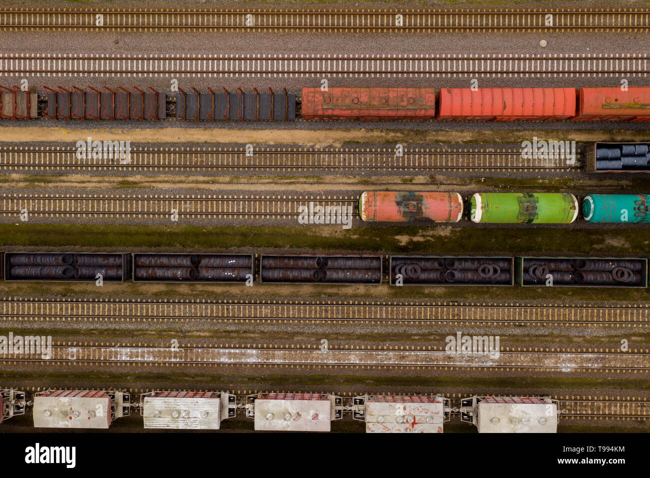 Aerial view of colorful freight trains with goods on the railway ...