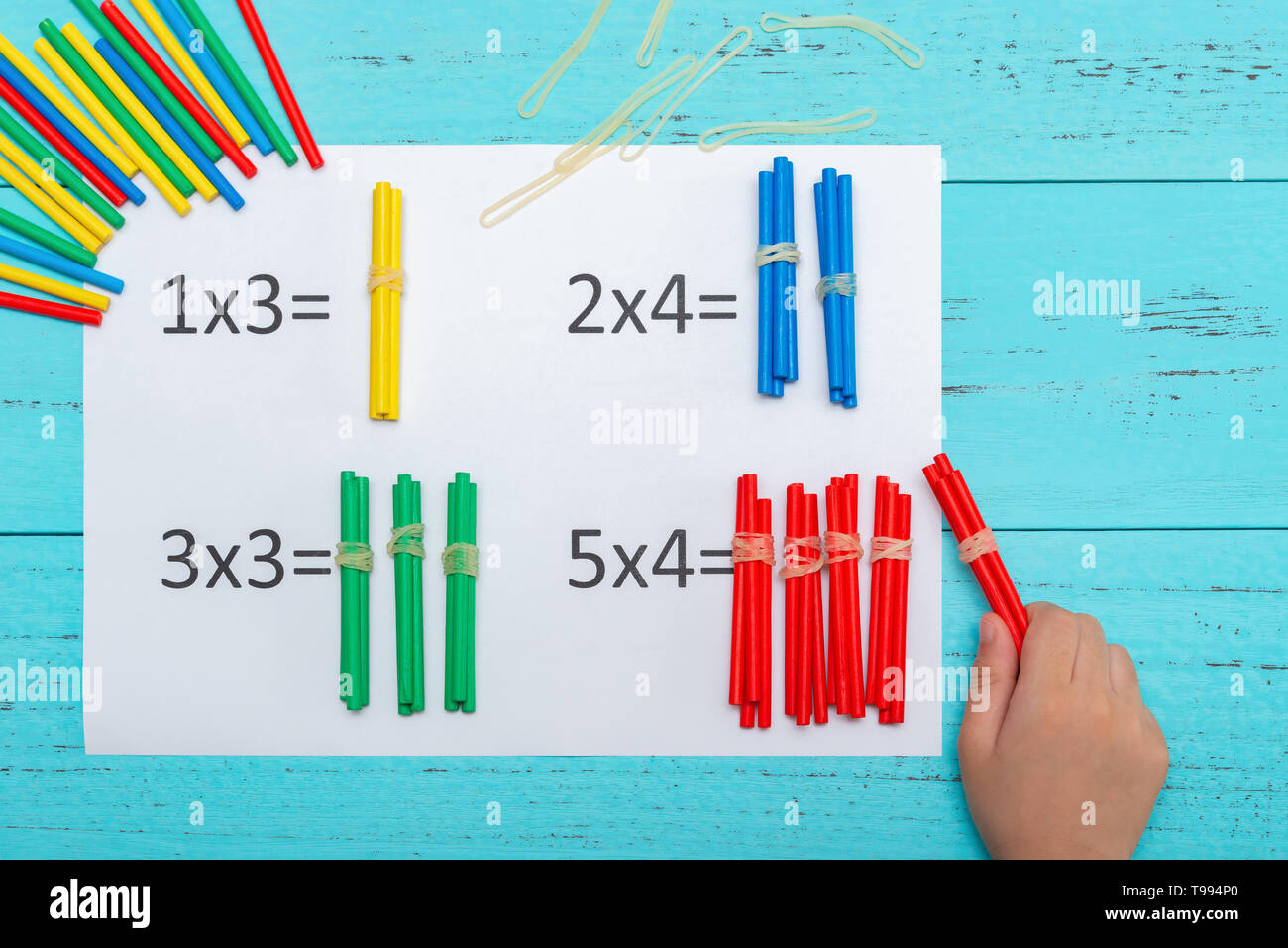 kid doing multiplication equations using counting rods Stock Photo - Alamy
