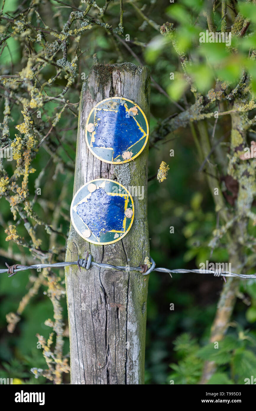 Directional arrows on a wooden fence post on a public footpath in ...