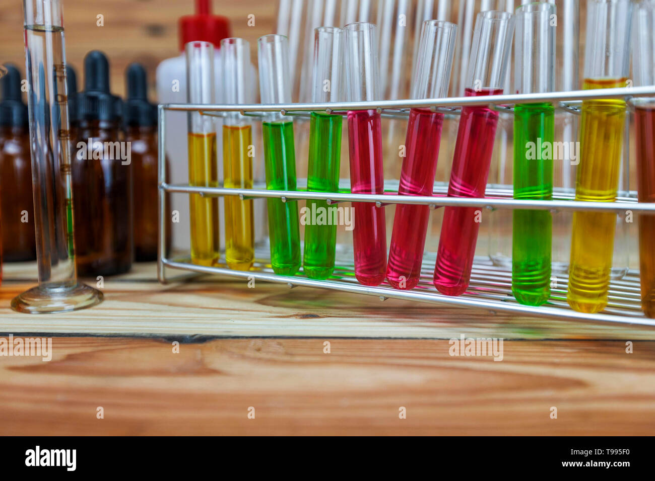 Stand with test tubes isolated on white. Several chemical solution in ...